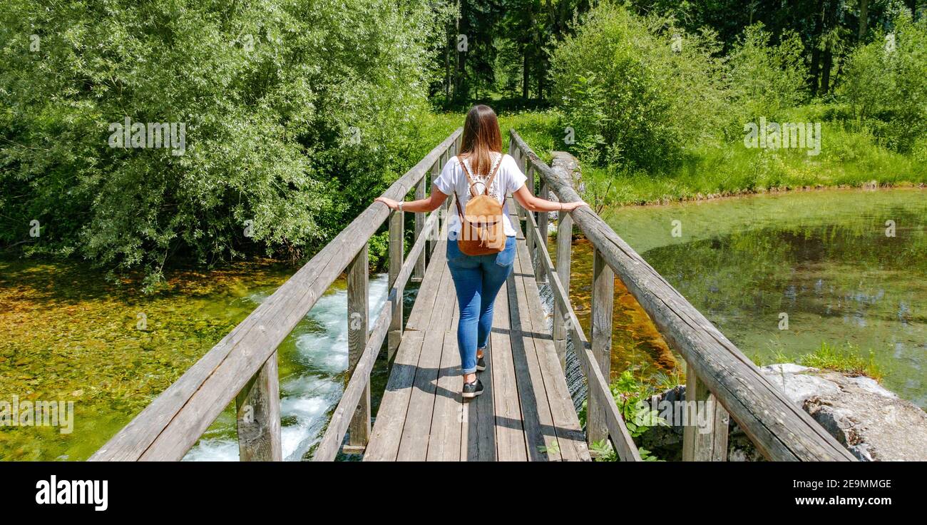 Back woman backpack wood bridge hi-res stock photography and images - Alamy