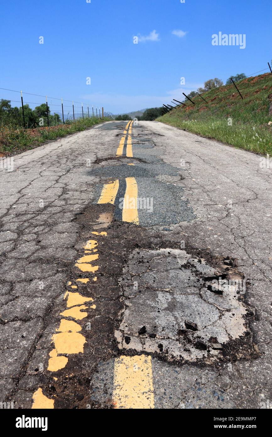 Pothole road - damaged roadway surface in California, USA Stock Photo ...