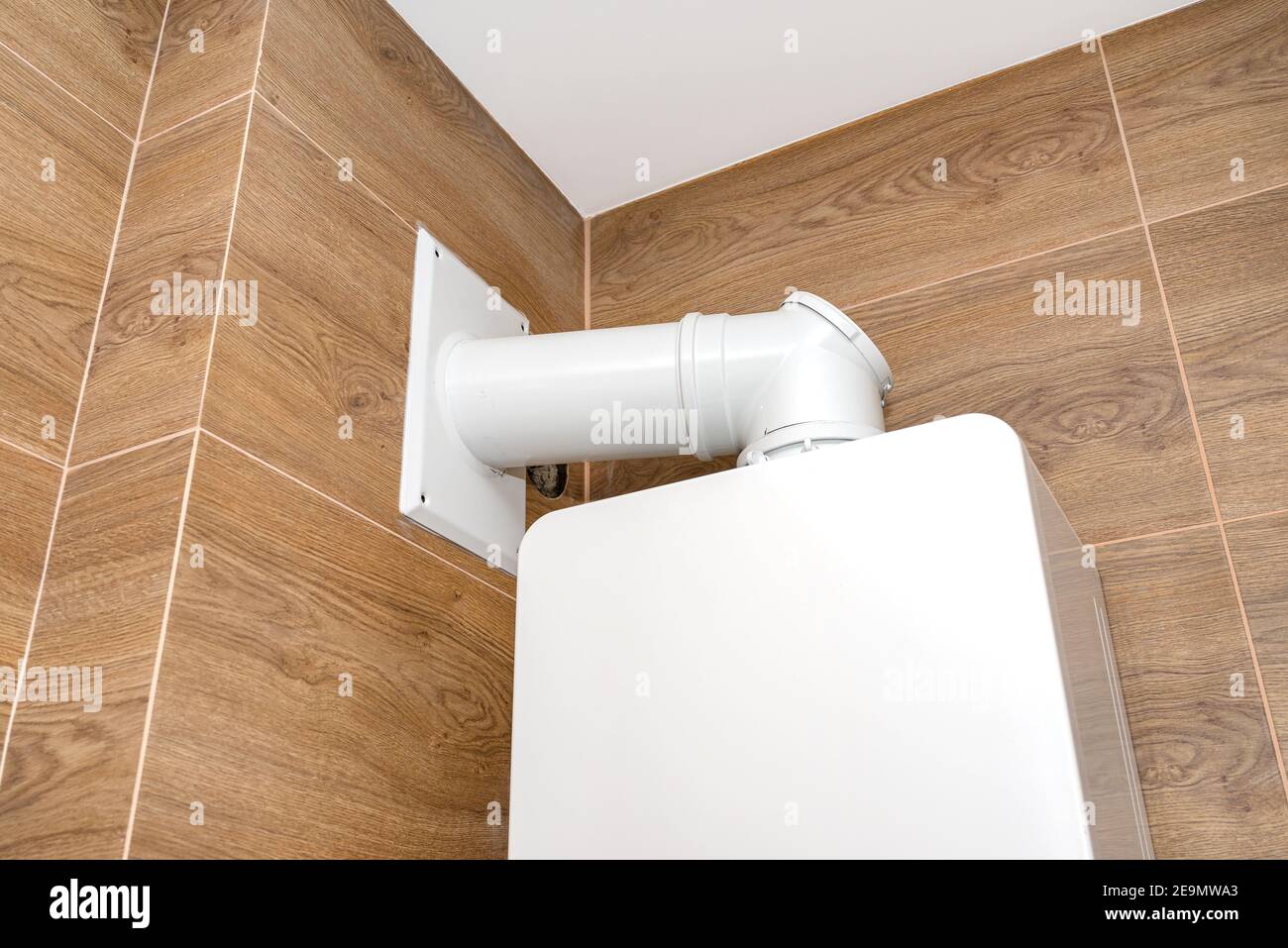 A modern gas boiler for natural gas, installed in a boiler room lined ...