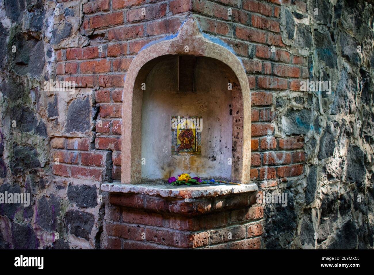 Small altar on the corner of a stone wall Stock Photo - Alamy