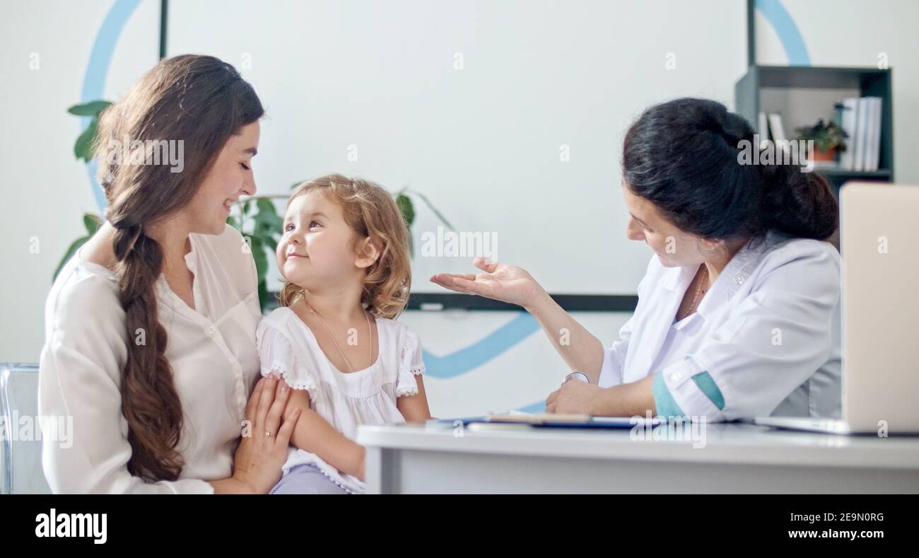 Female Family Doctor Examining and Consulting to Mother and Her Child ...