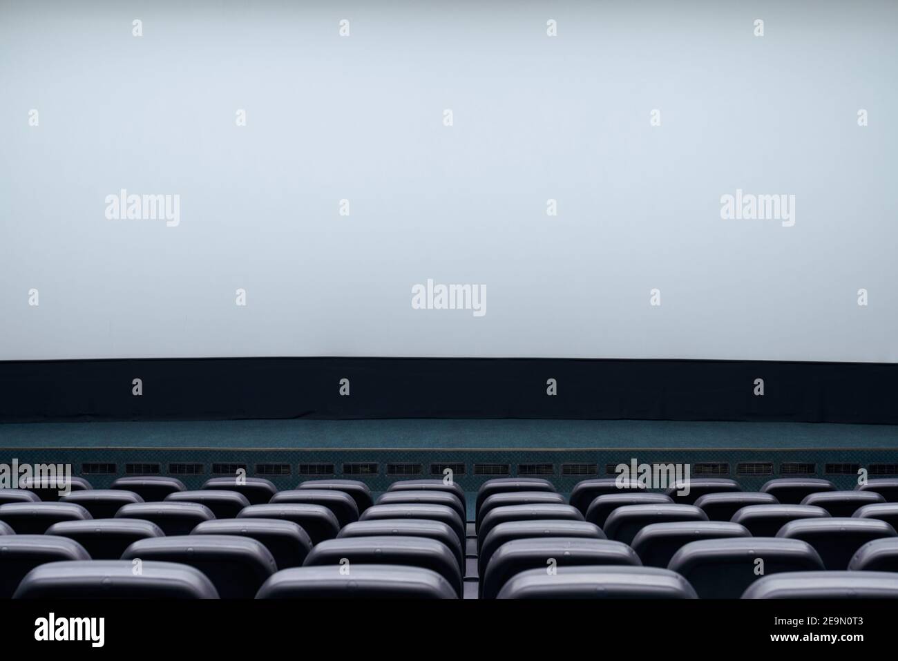 Close up of large blank screen and rows comfortable black seats for ...