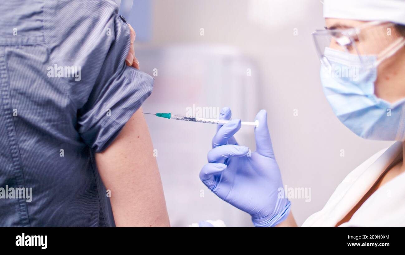 Medical Nurse in Safety Gloves and Protective Mask is Making a Vaccine ...
