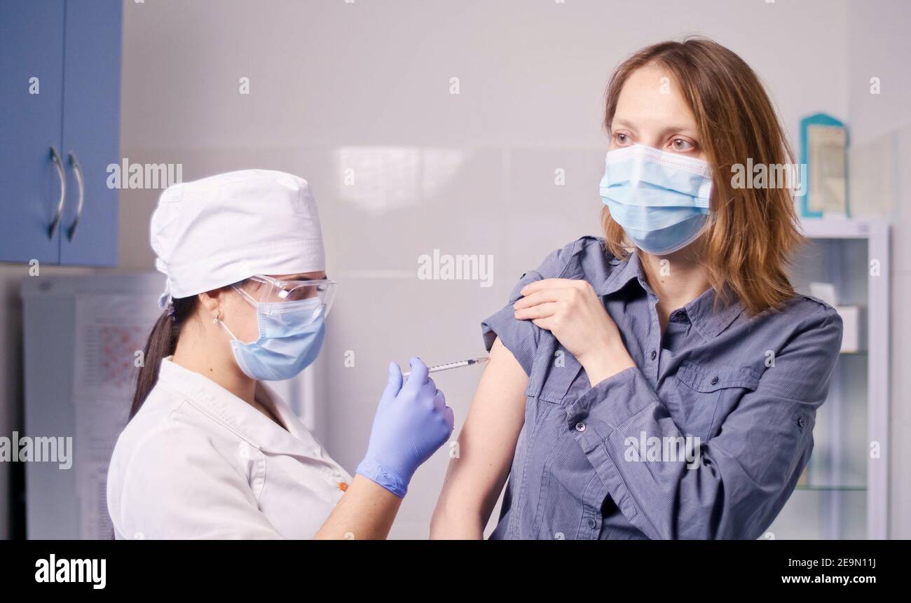 Medical Nurse in Safety Gloves and Protective Mask is Making a Vaccine ...