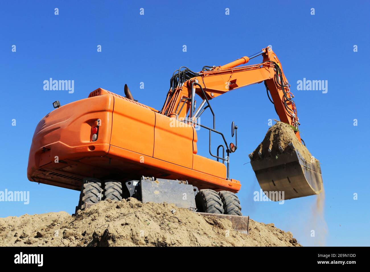 Excavation work with excavator on a building site Stock Photo - Alamy