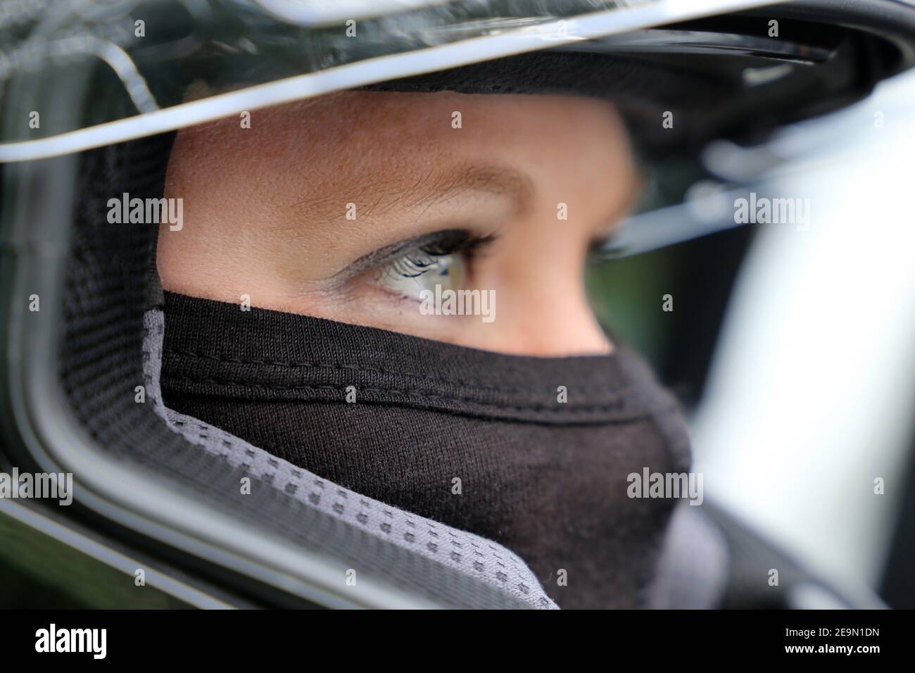 Symbol image: Female race car driver wears helmet and balaclava (model ...