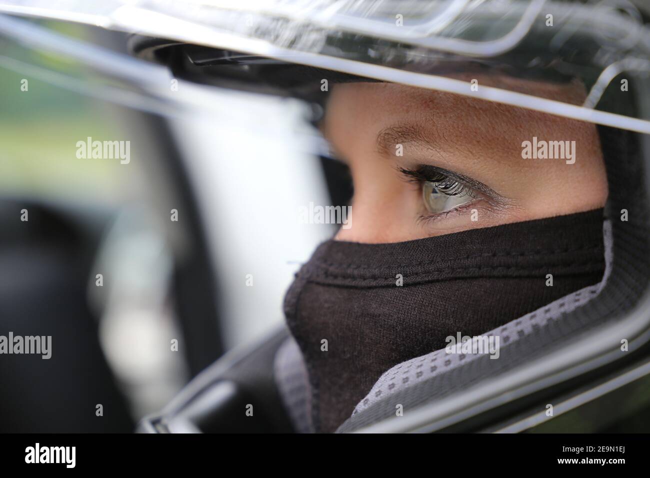Symbol image: Female race car driver wears helmet and balaclava (model ...