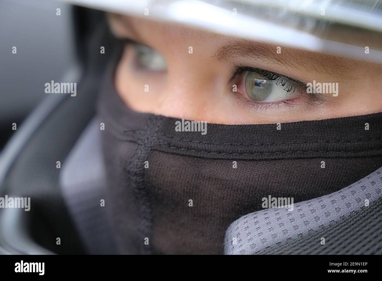 Symbol image: Female race car driver wears helmet and balaclava (model ...