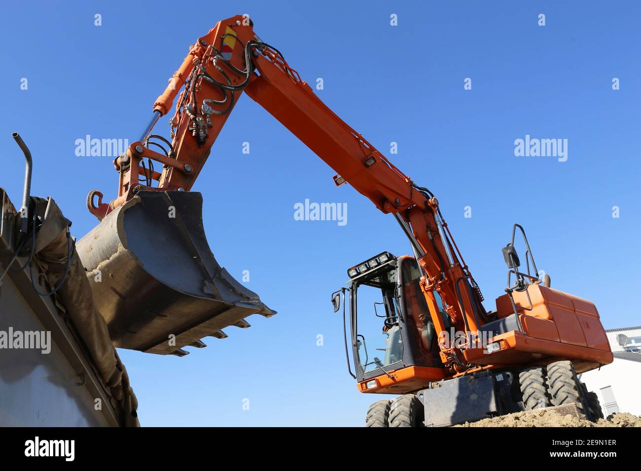 Excavation work with excavator on a building site Stock Photo - Alamy