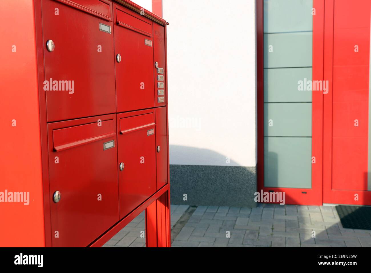 Modern freestanding letterbox with doorbell Stock Photo - Alamy