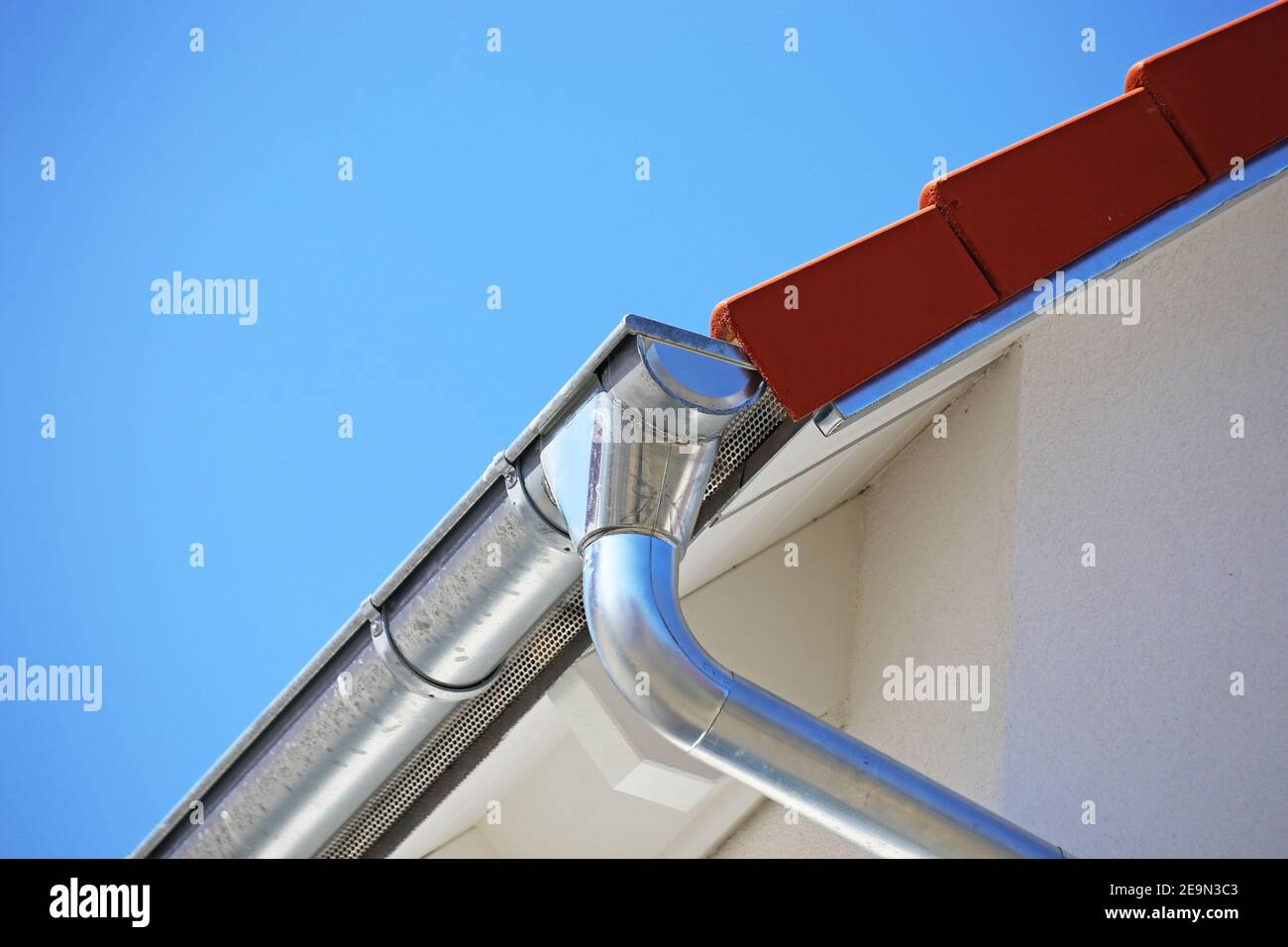 Roof gutter on a new tiled roof Stock Photo - Alamy