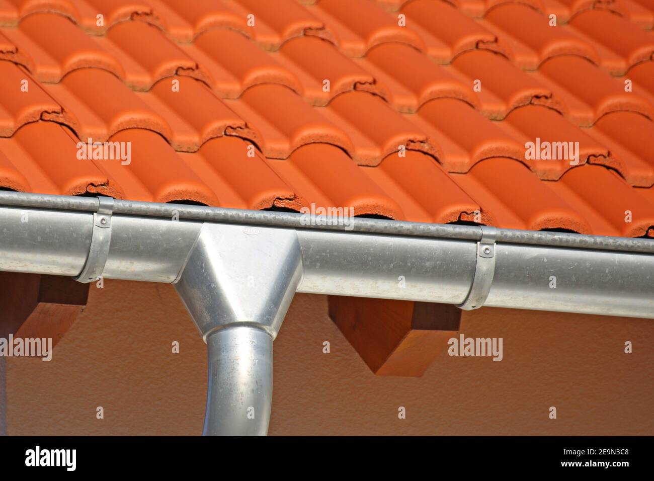 Roof gutter on a new tiled roof Stock Photo - Alamy