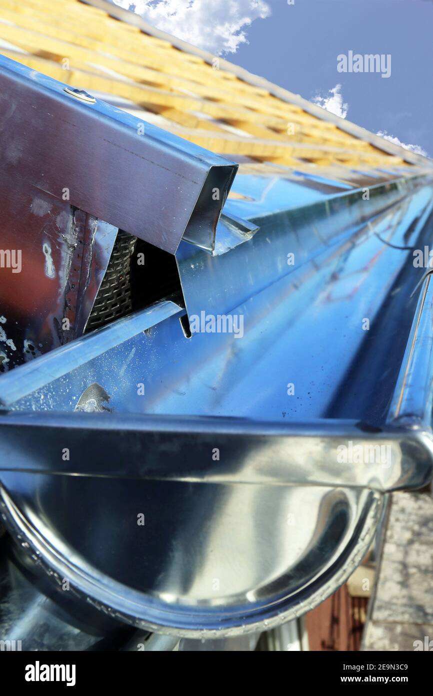 Roof gutter on a new tiled roof Stock Photo - Alamy