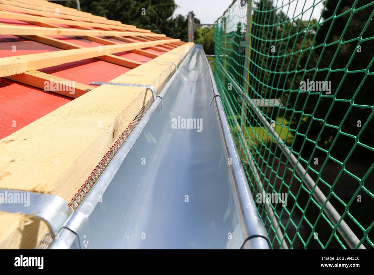 Roof gutter on a new tiled roof Stock Photo - Alamy