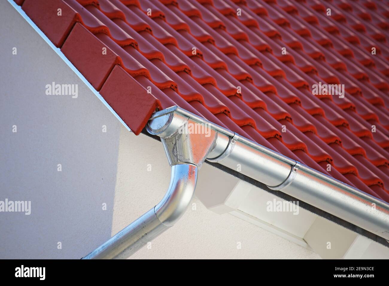 Roof gutter on a new tiled roof Stock Photo - Alamy