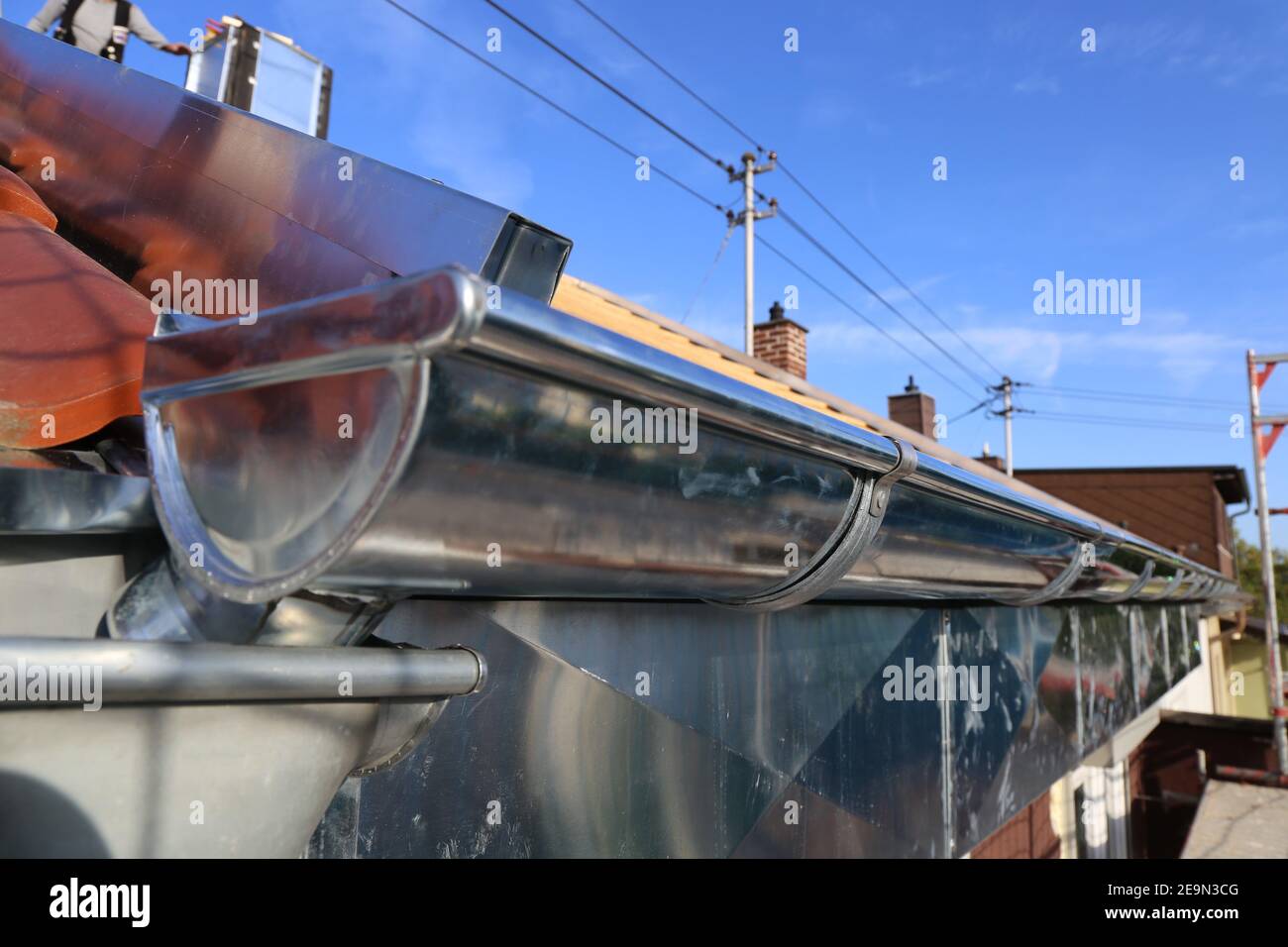 Roof gutter on a new tiled roof Stock Photo - Alamy