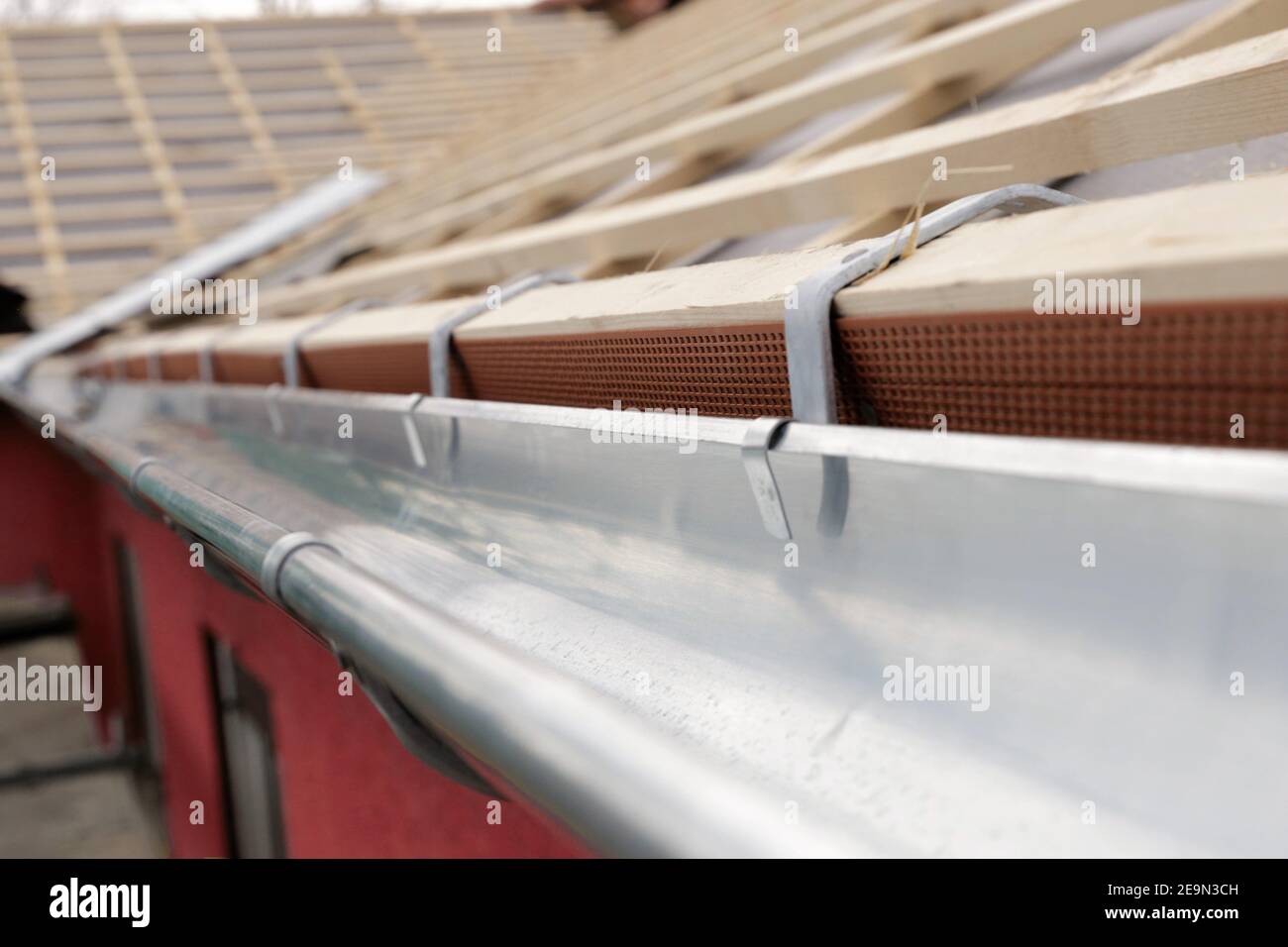 Roof gutter on a new tiled roof Stock Photo - Alamy