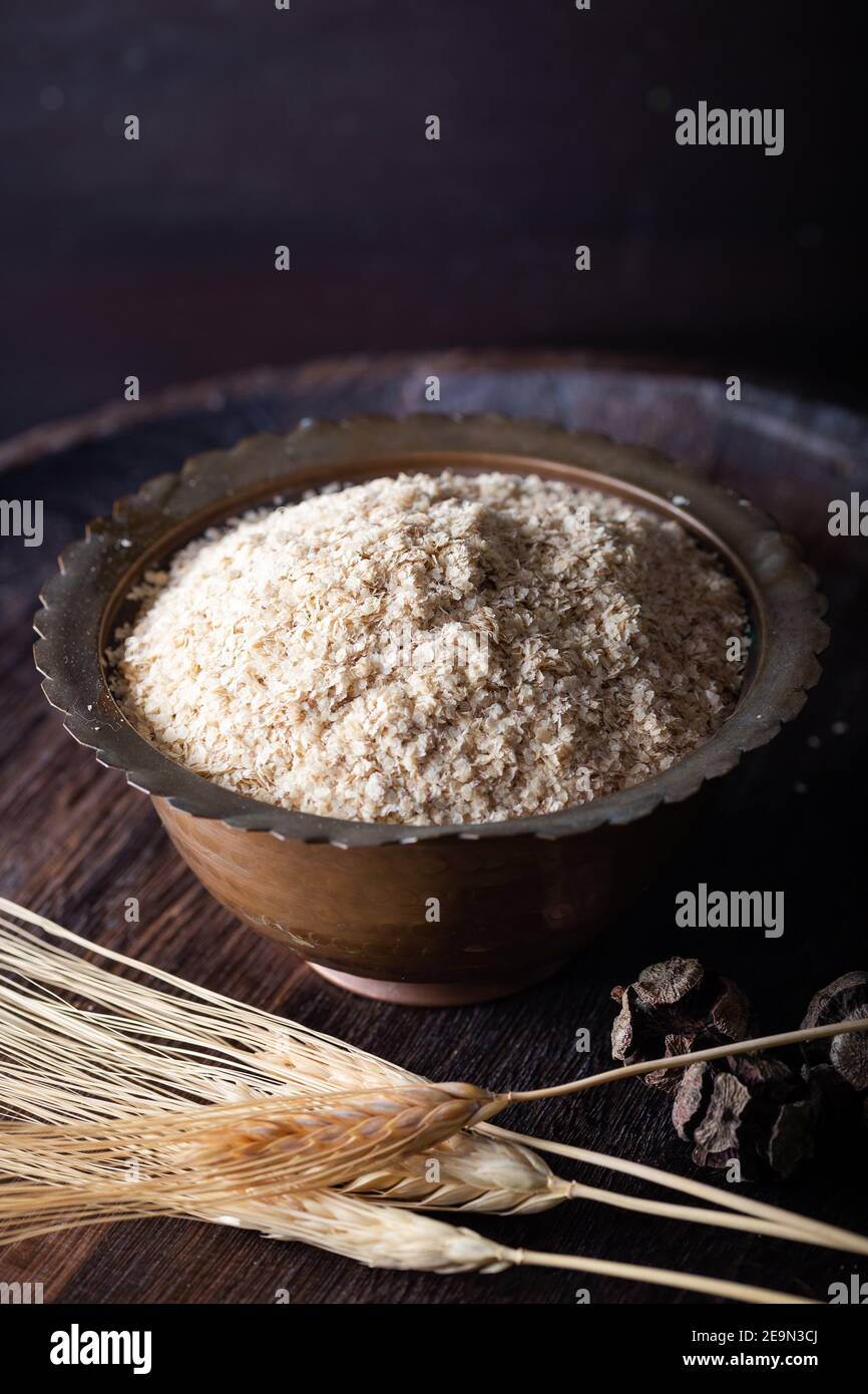 Raw wheat germ in the metal bowl on wooden background. Wheat germ in ...