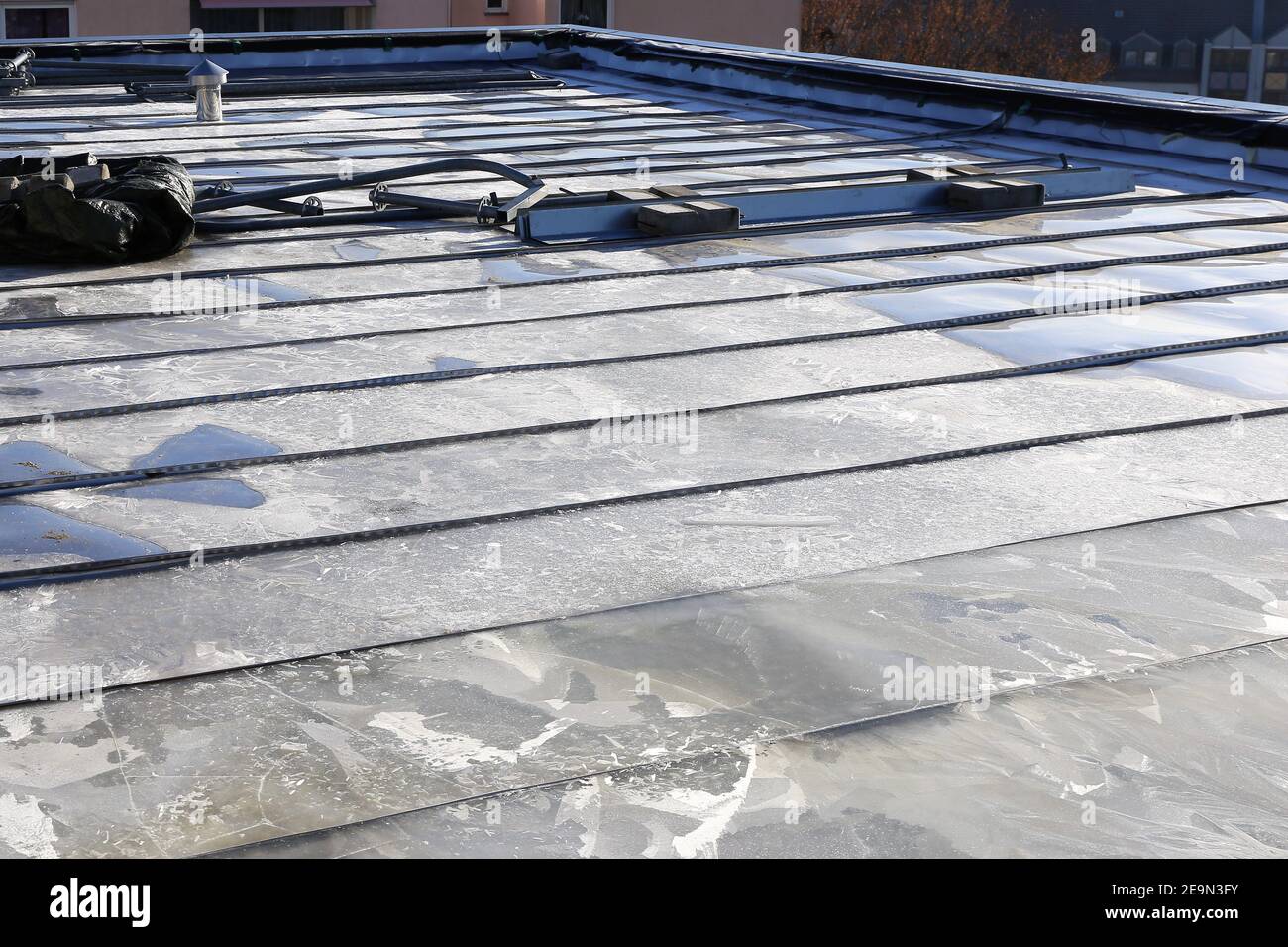 Roll seam welded stainless steel flat roof on a building Stock Photo ...