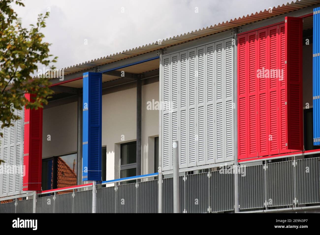 Large modern folding sliding shutters on a building Stock Photo - Alamy