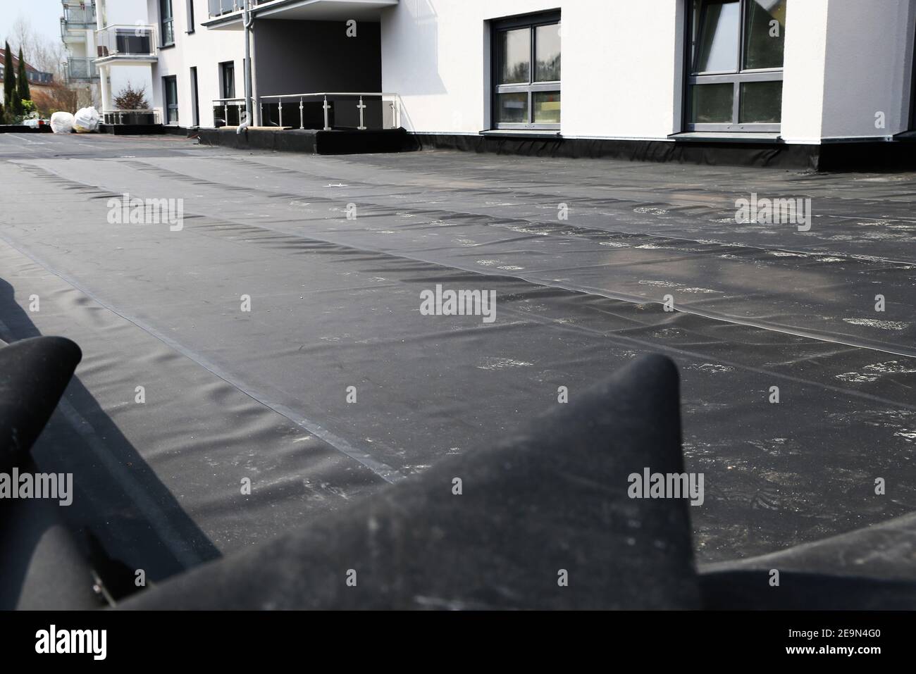 Professional flat roof waterproofing with bitumen welded sheeting Stock Photo - Alamy