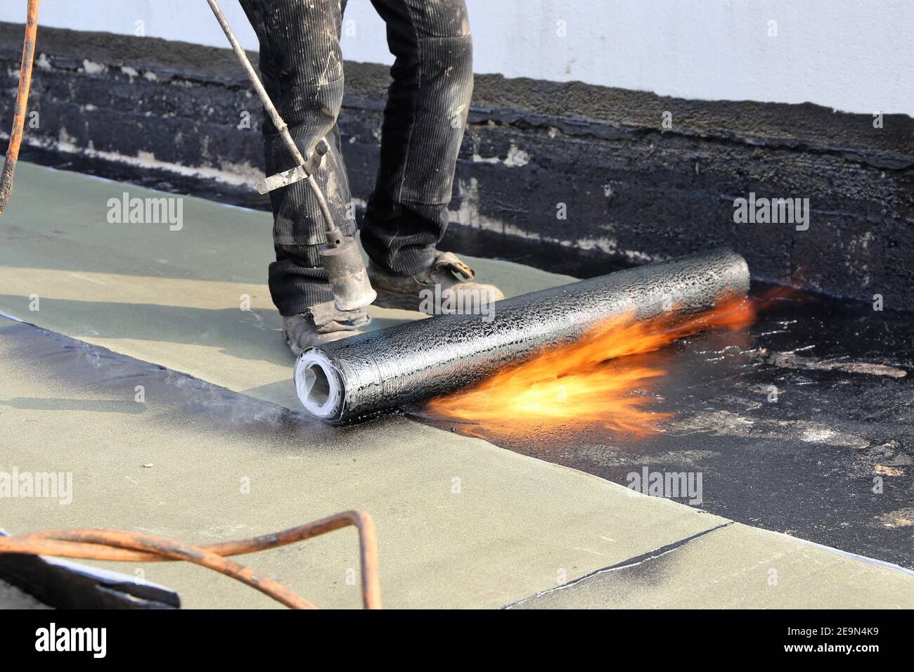 Professional flat roof waterproofing with bitumen welded sheeting Stock Photo - Alamy