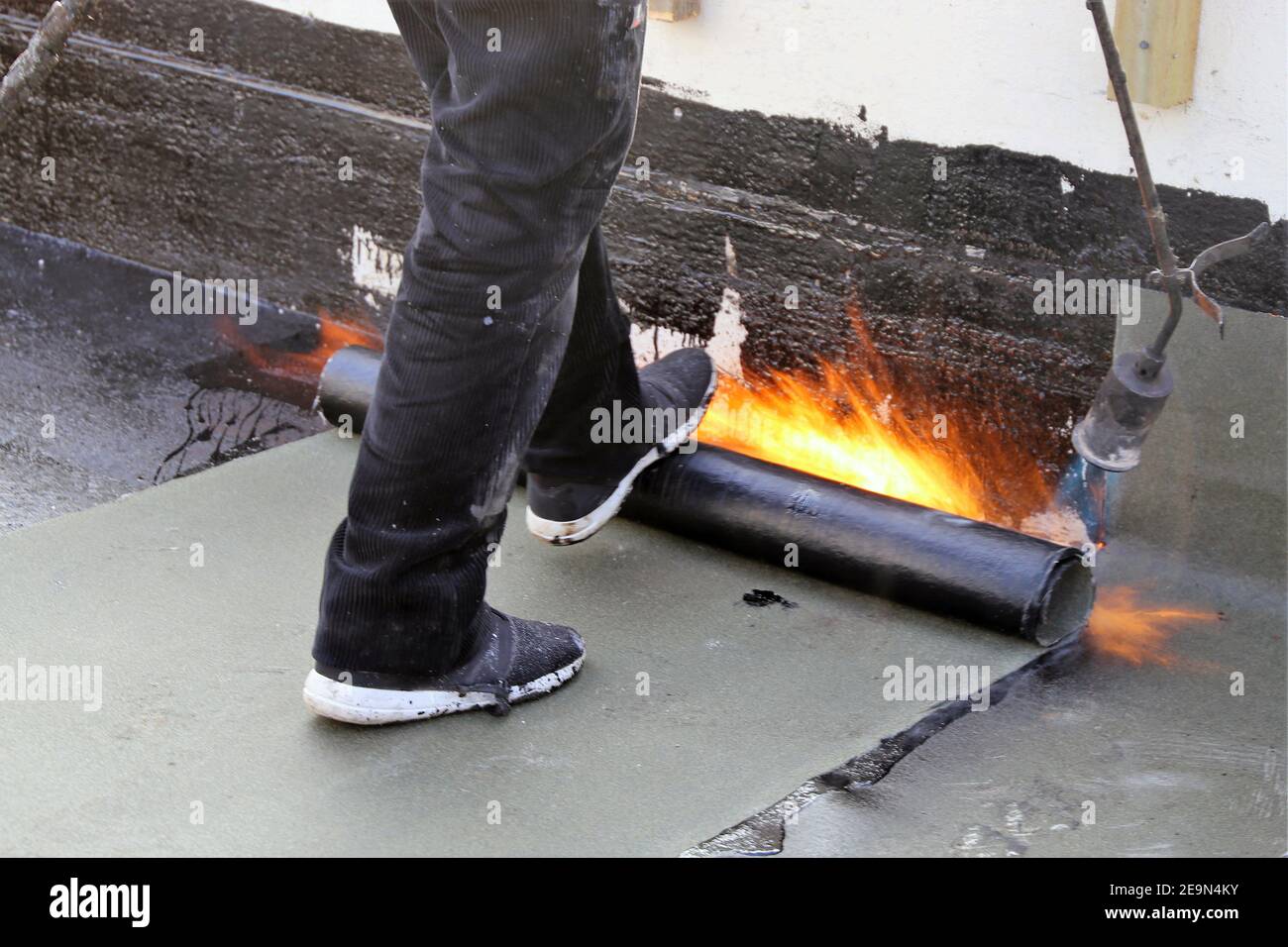 Professional flat roof waterproofing with bitumen welded sheeting Stock Photo - Alamy