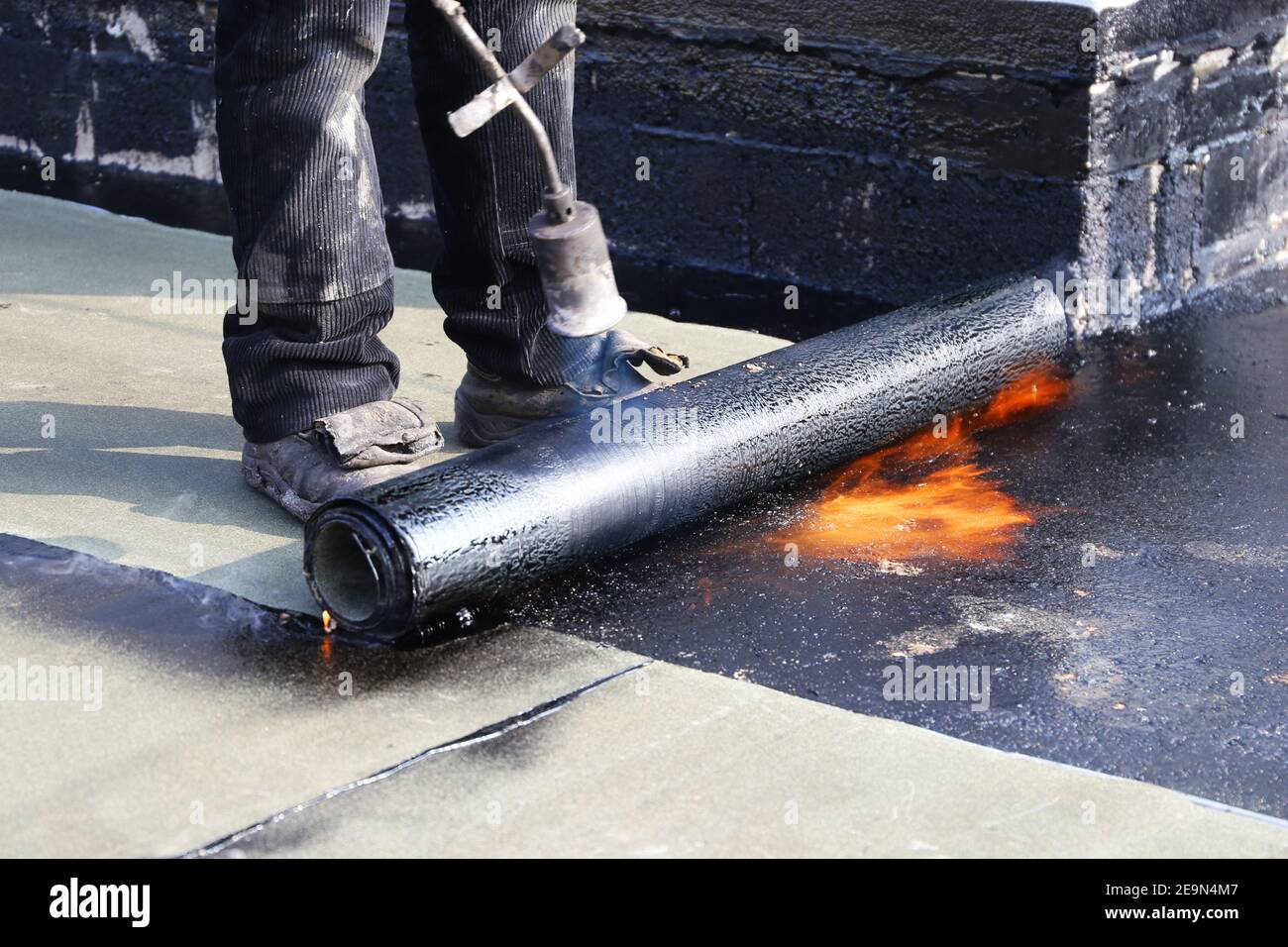 Professional flat roof waterproofing with bitumen welded sheeting Stock Photo - Alamy