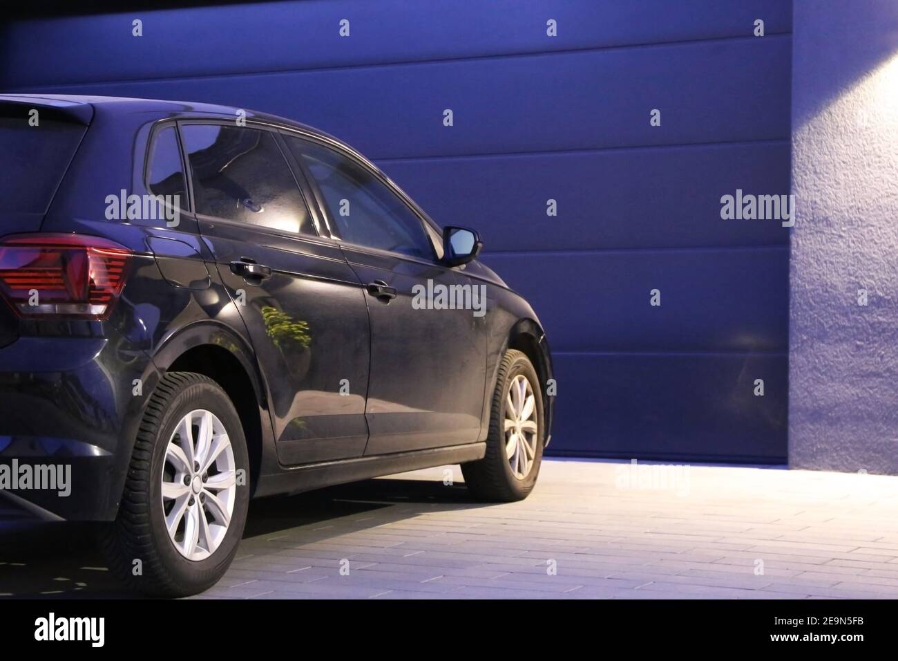 Modern new garage door (sectional door) at night Stock Photo - Alamy
