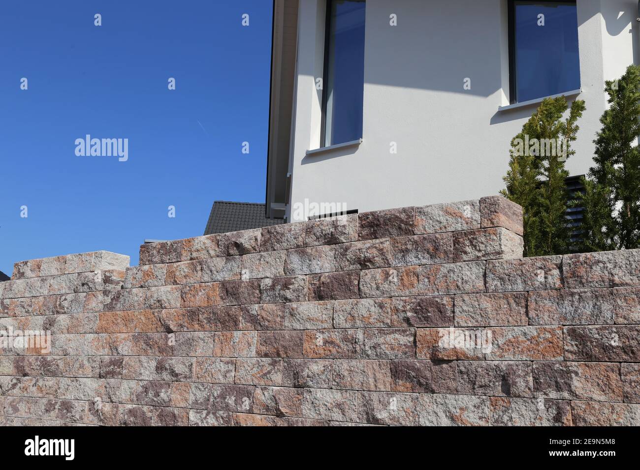 Natural stone wall as a property line and sight protection Stock Photo ...