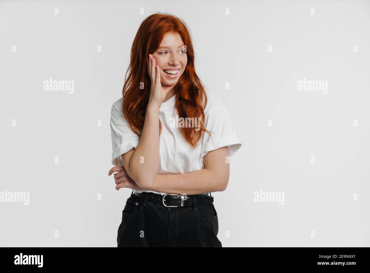 Ginger beautiful happy girl smiling and looking aside isolated over ...