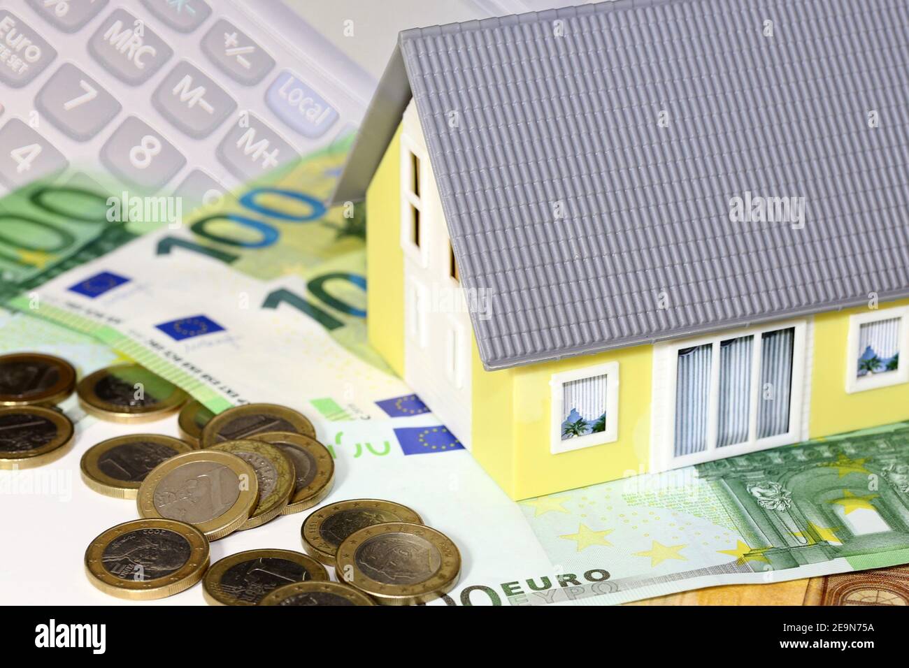 Symbol image: Model house with (euro)banknotes and coins as a symbol ...
