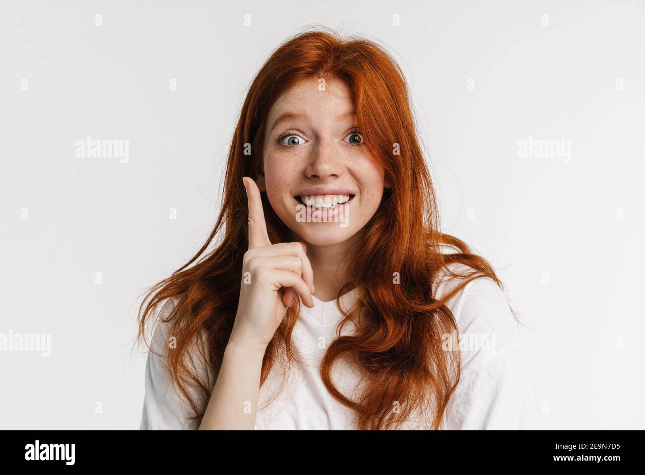 Ginger Beautiful Excited Girl Exclaiming And Pointing Finger Upward