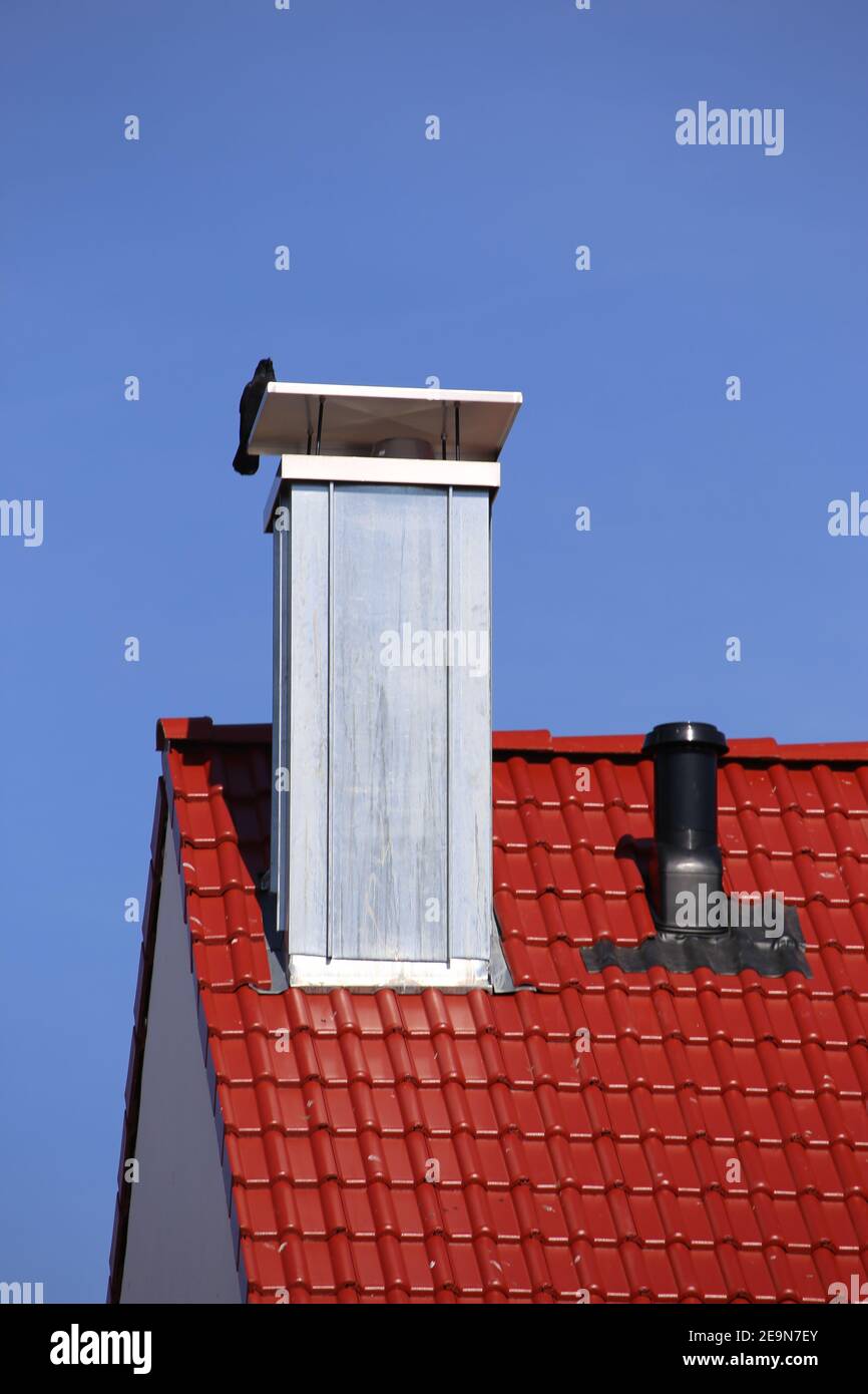 Chimney with stainless steel cladding on a newly covered roof Stock ...