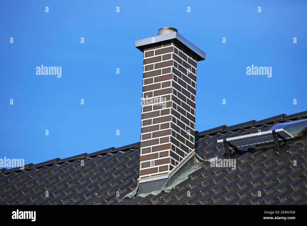 Chimney clad with clinker bricks on a newly covered roof Stock Photo ...