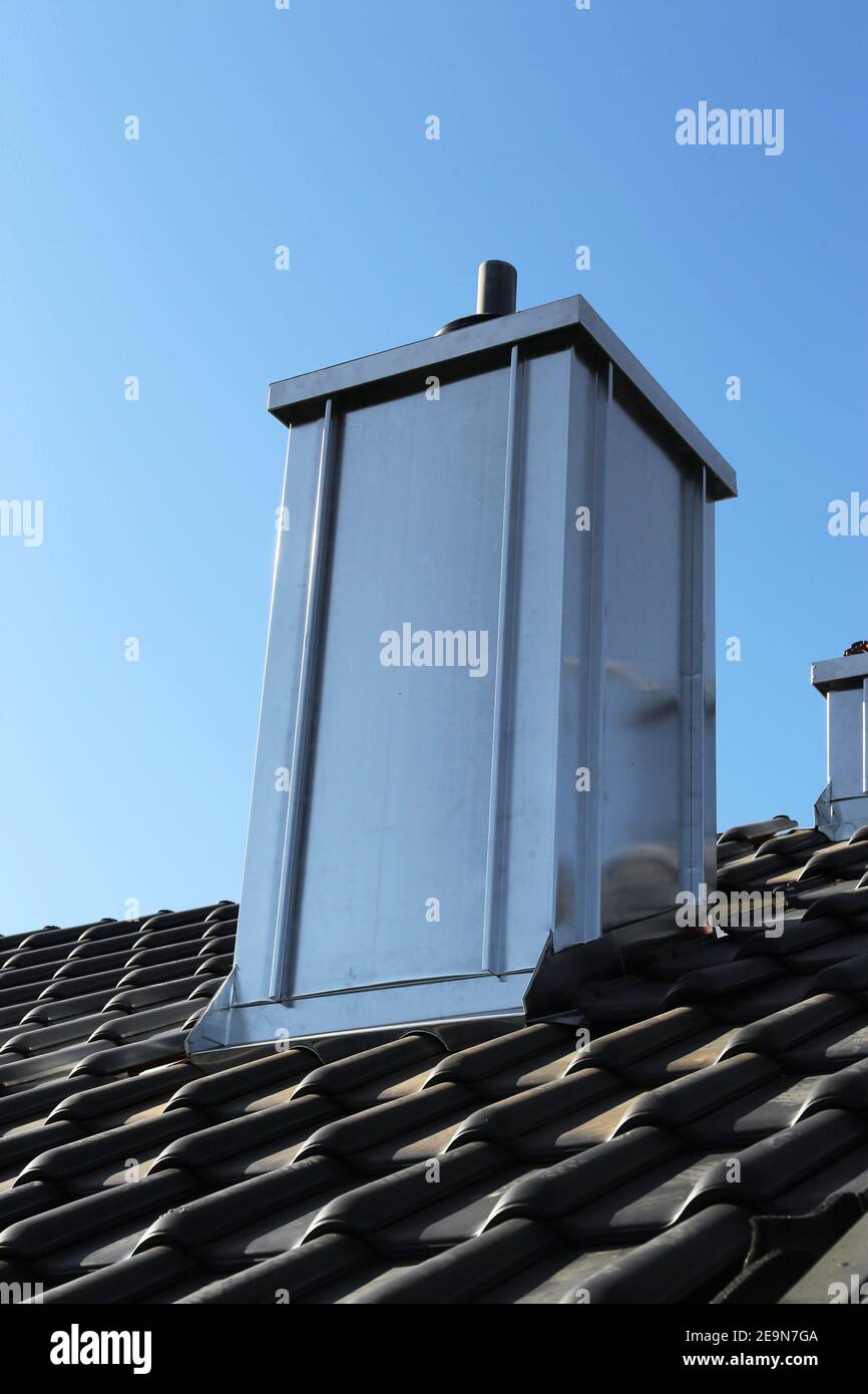 Chimney with stainless steel cladding on a newly covered roof Stock ...