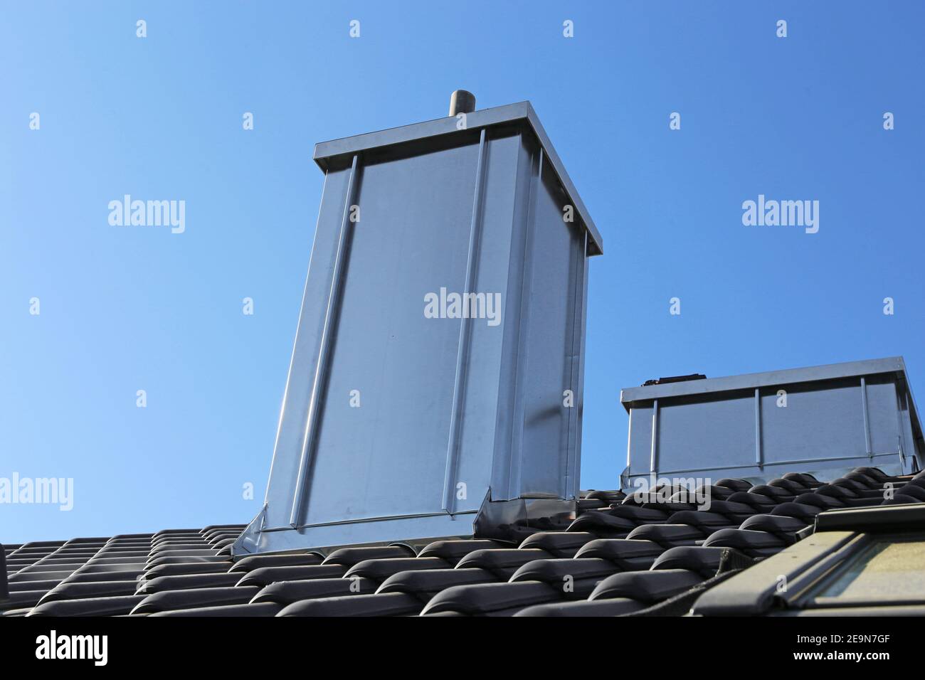 Chimney with stainless steel cladding on a newly covered roof Stock ...