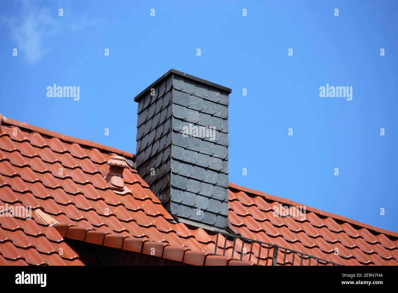 New tiled roof with slate cladded chimney Stock Photo - Alamy