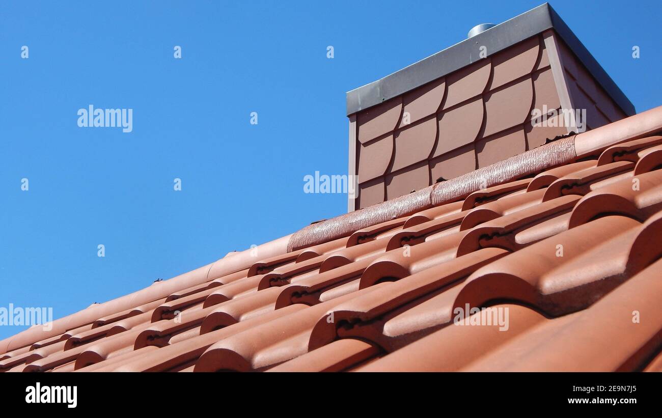 Newly covered roof with also newly covered chimney Stock Photo - Alamy