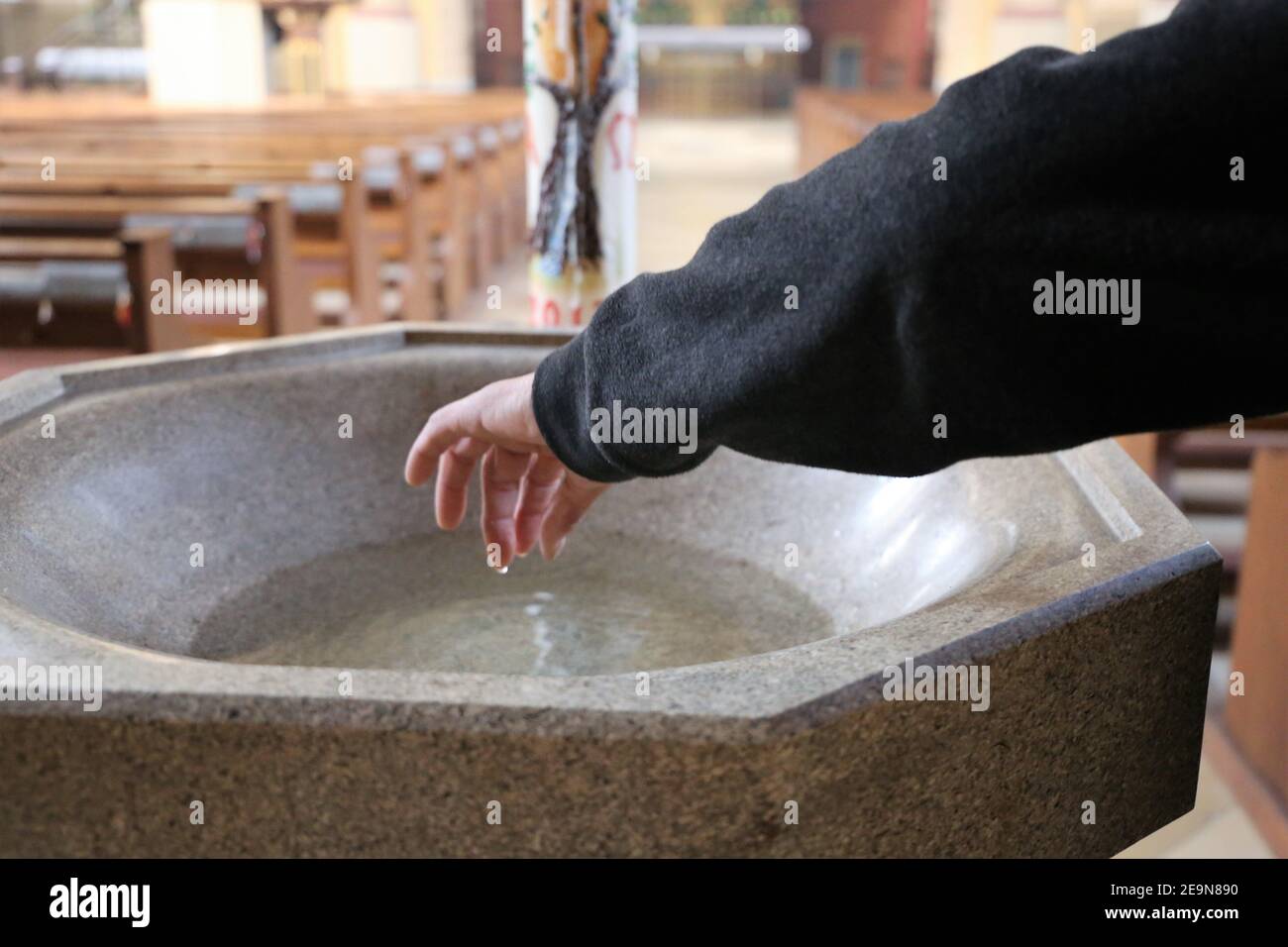 Symbol image: Hand in holy water Stock Photo - Alamy