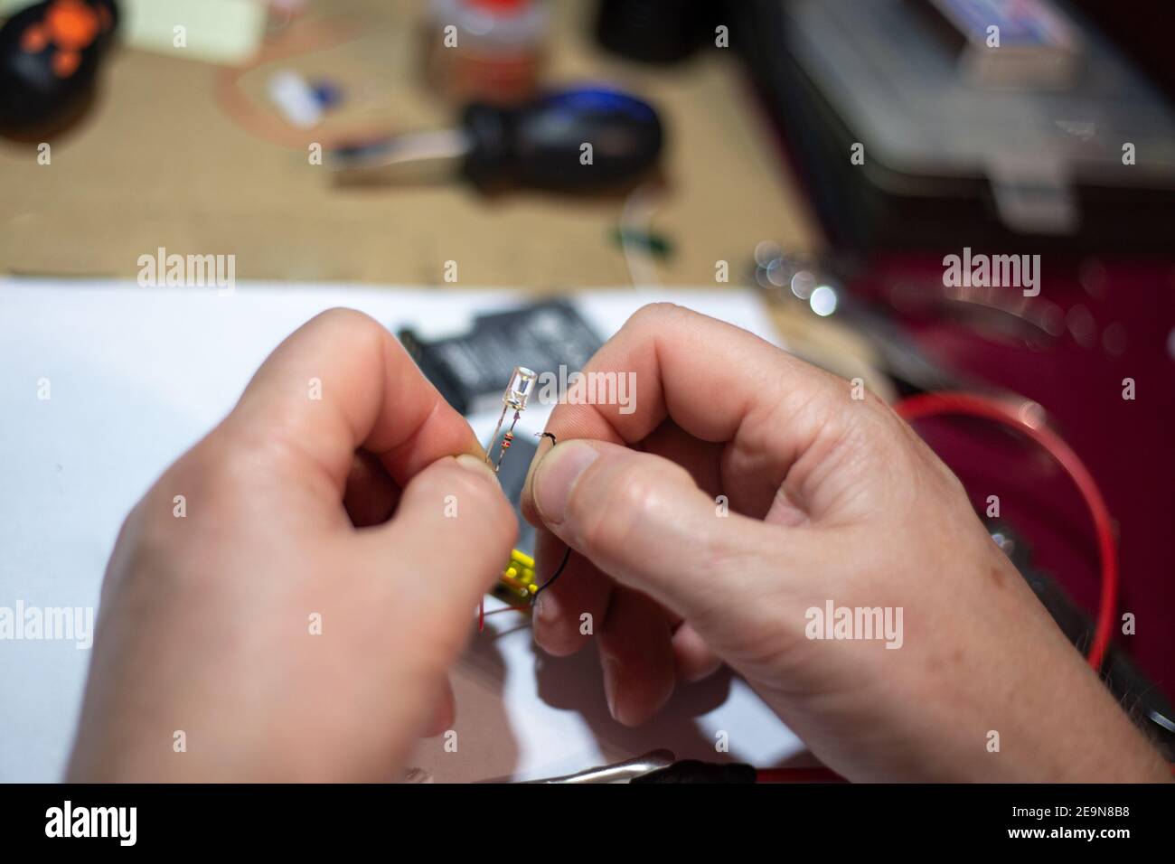 a man is repairing an LED that he holds in his hands Stock Photo - Alamy