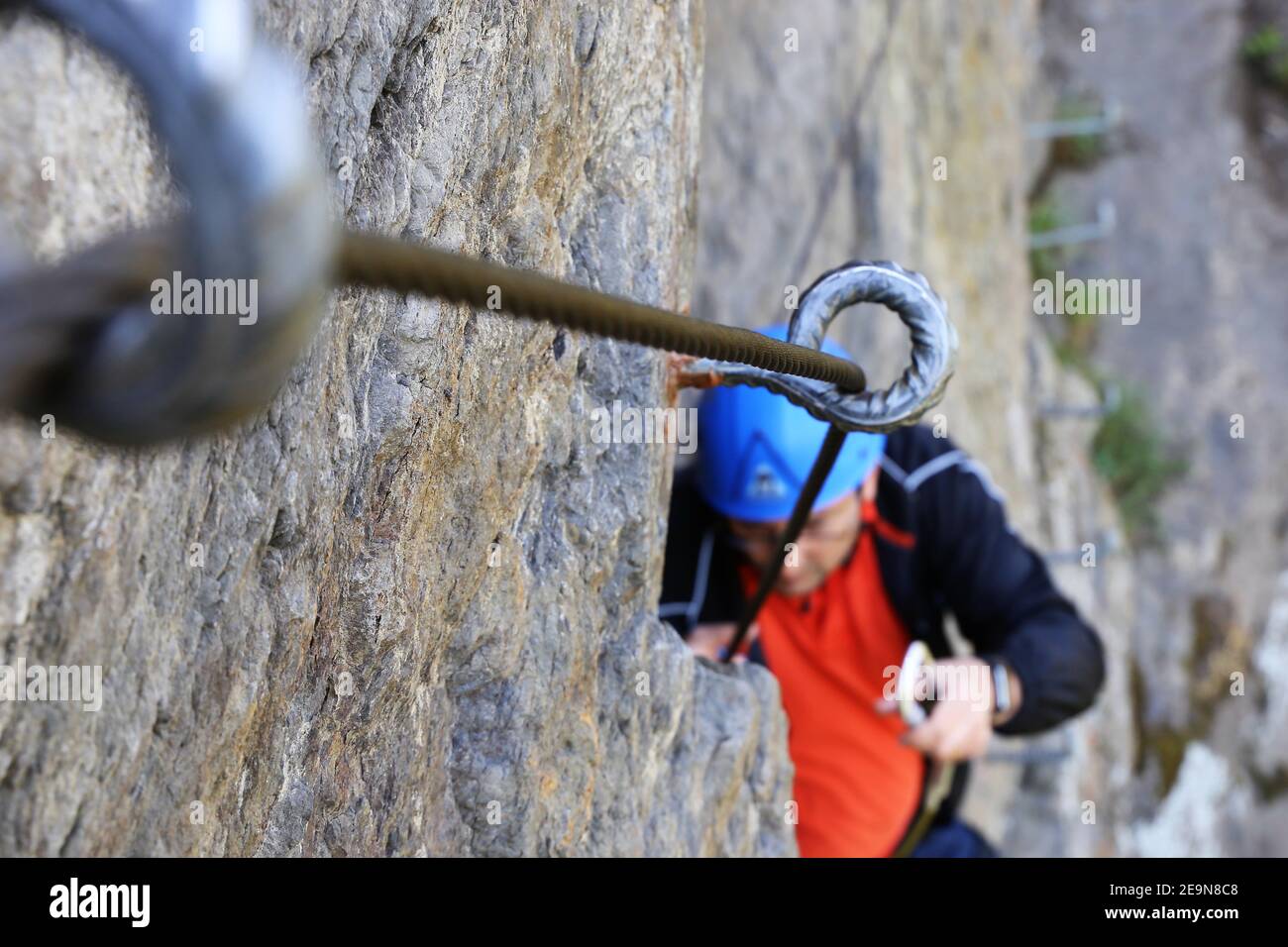 Man climbing via ferrata Stock Photo - Alamy