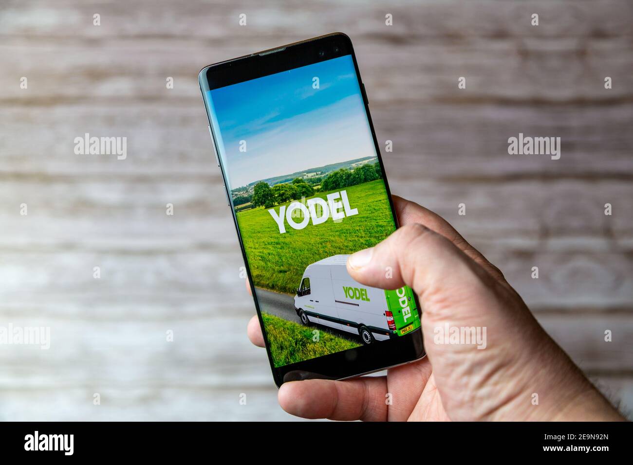 A Mobile phone or cell phone being held showing the Yodel delivery app ...