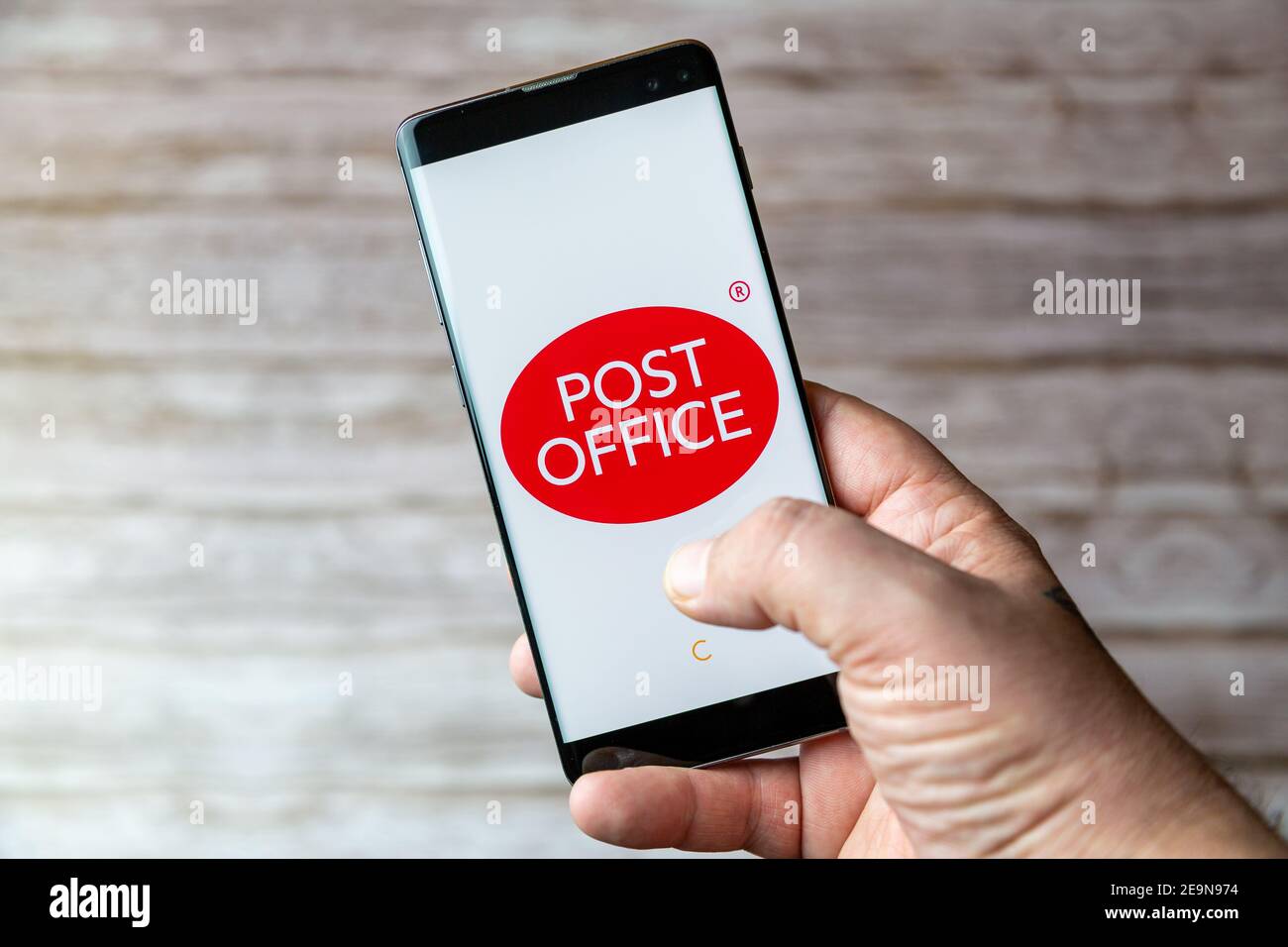 A Mobile phone or cell phone being held showing the Post office app ...