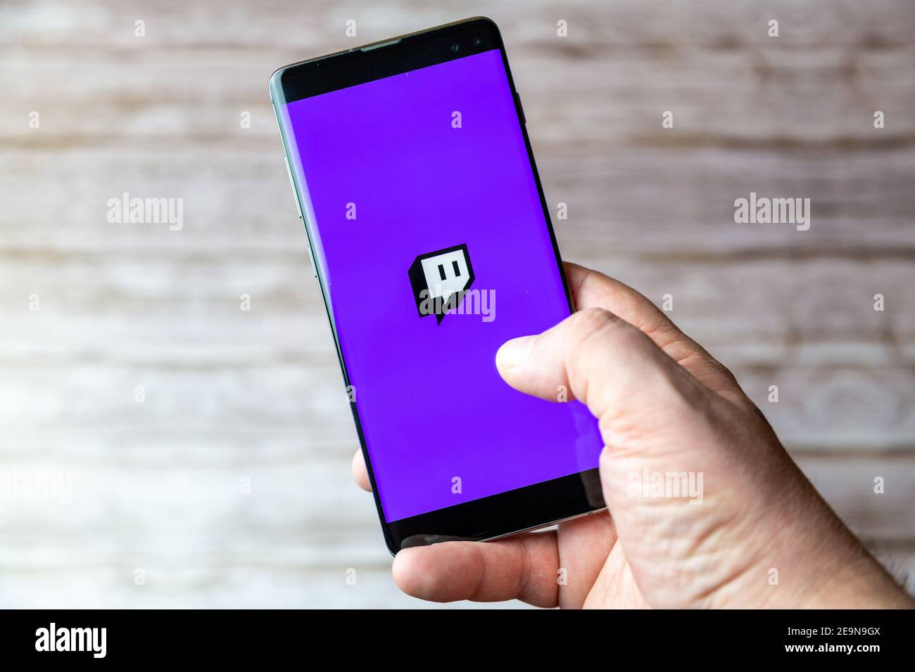 A Mobile phone or cell phone being held showing the Twitch streaming ...
