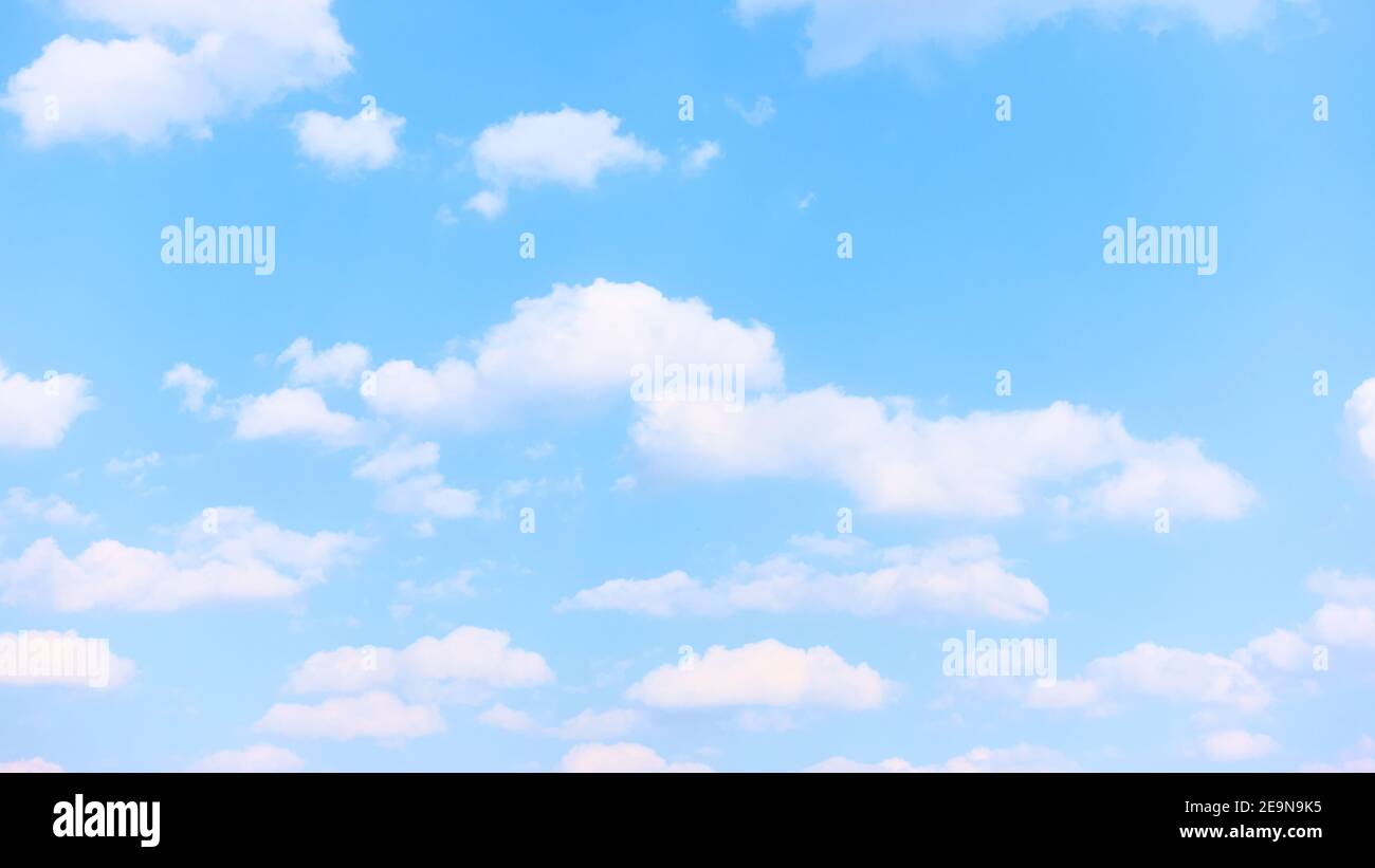 Light blue spring sky with white clouds - panoramic background with ...
