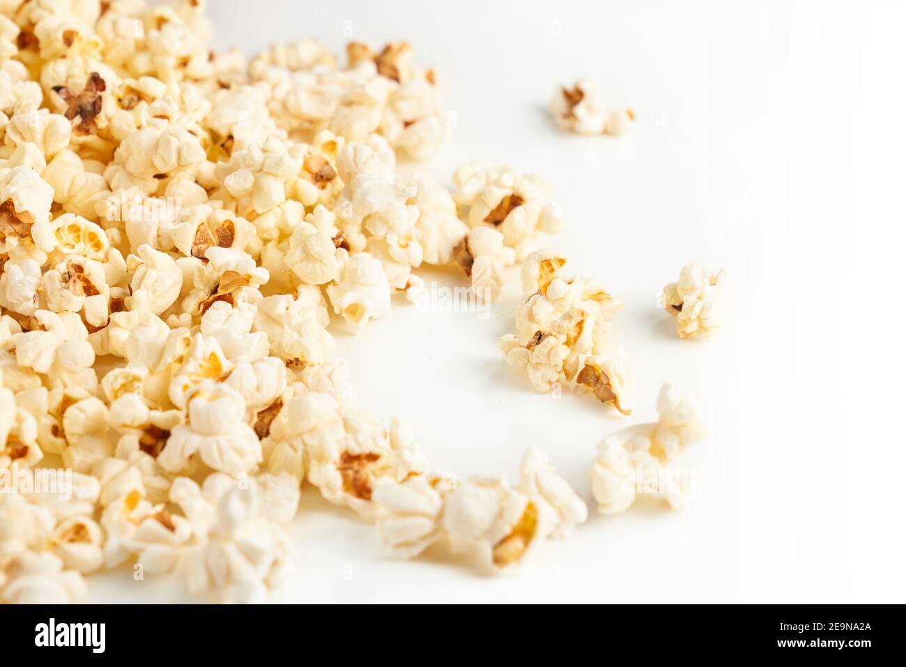 Popcorn grains on the white background. Concept of scattered popcorn ...