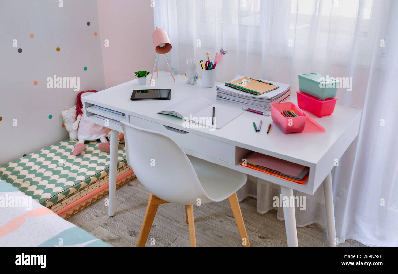 Desk in girl's bedroom decorated in pastel colors Stock Photo - Alamy