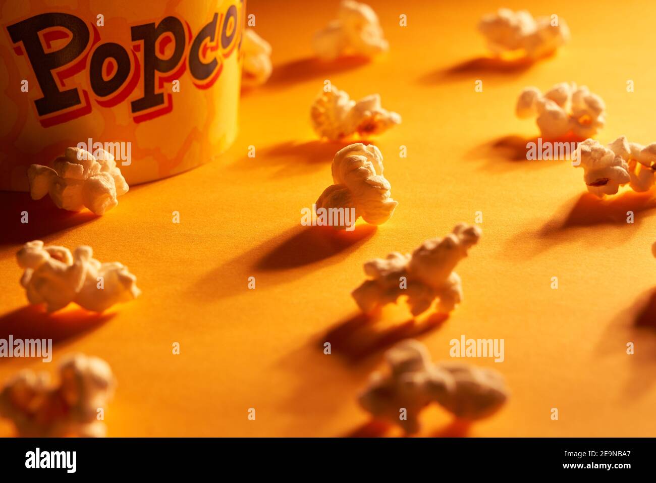 Close up of different popcorn with orange light and orange background ...