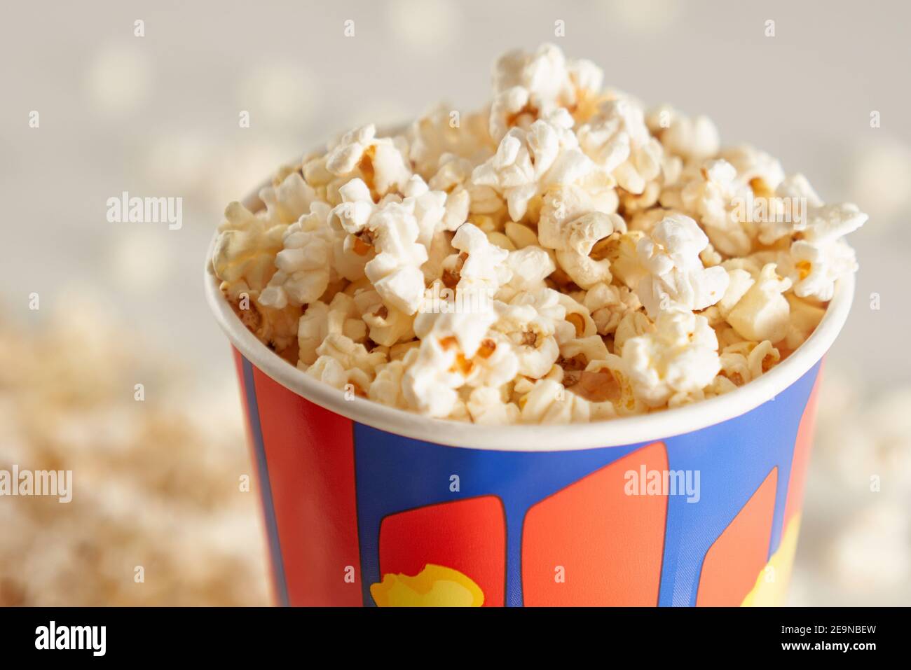 Bucket with popcorn on blurred background. Concept cinema with popcorn ...
